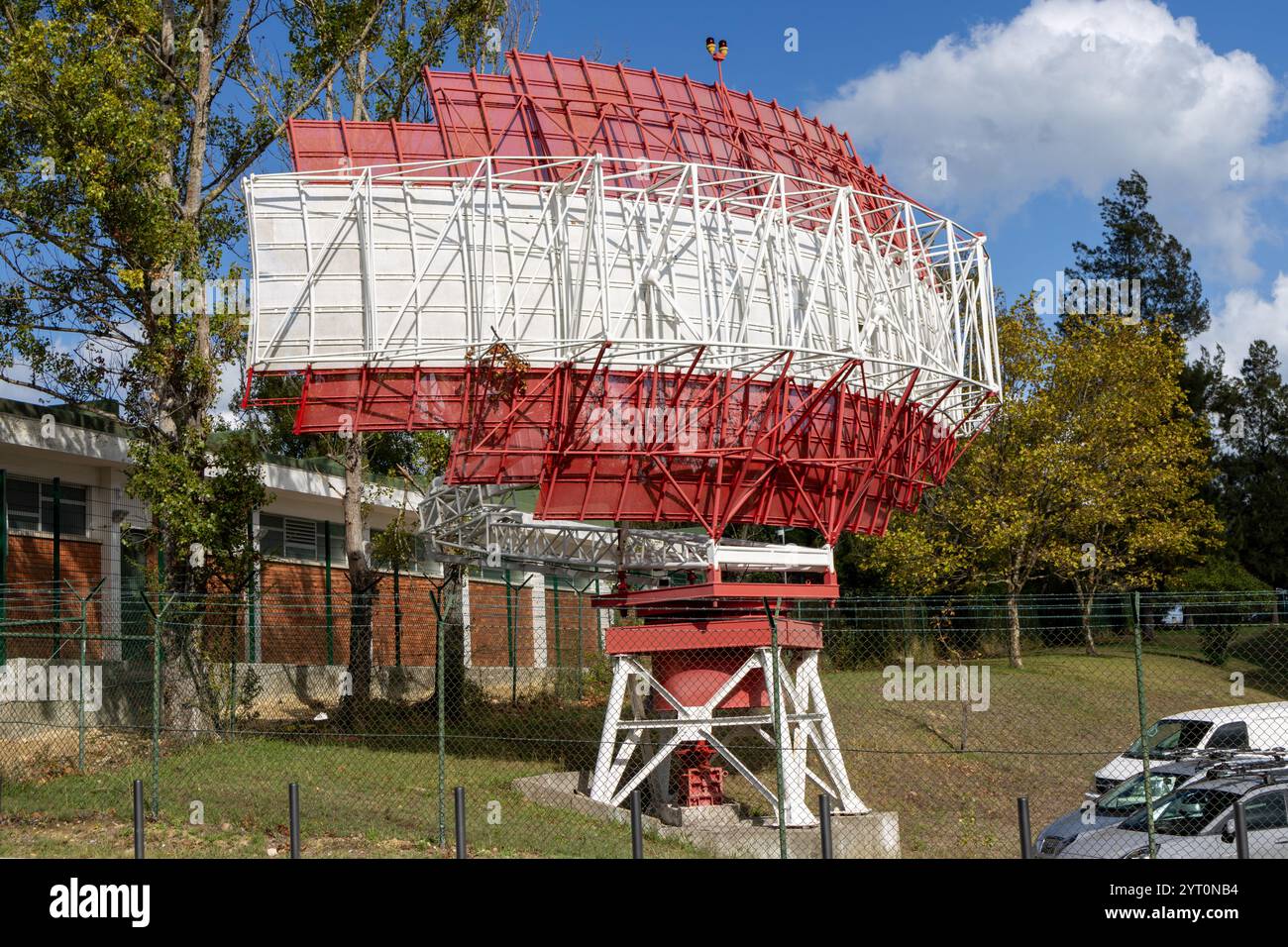 Red and white radar antenna rotating and scanning the sky for incoming ...