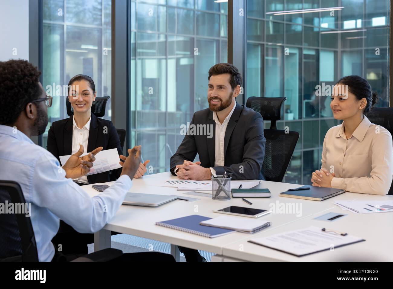 A diverse team engaged in a productive office meeting, focusing on ...