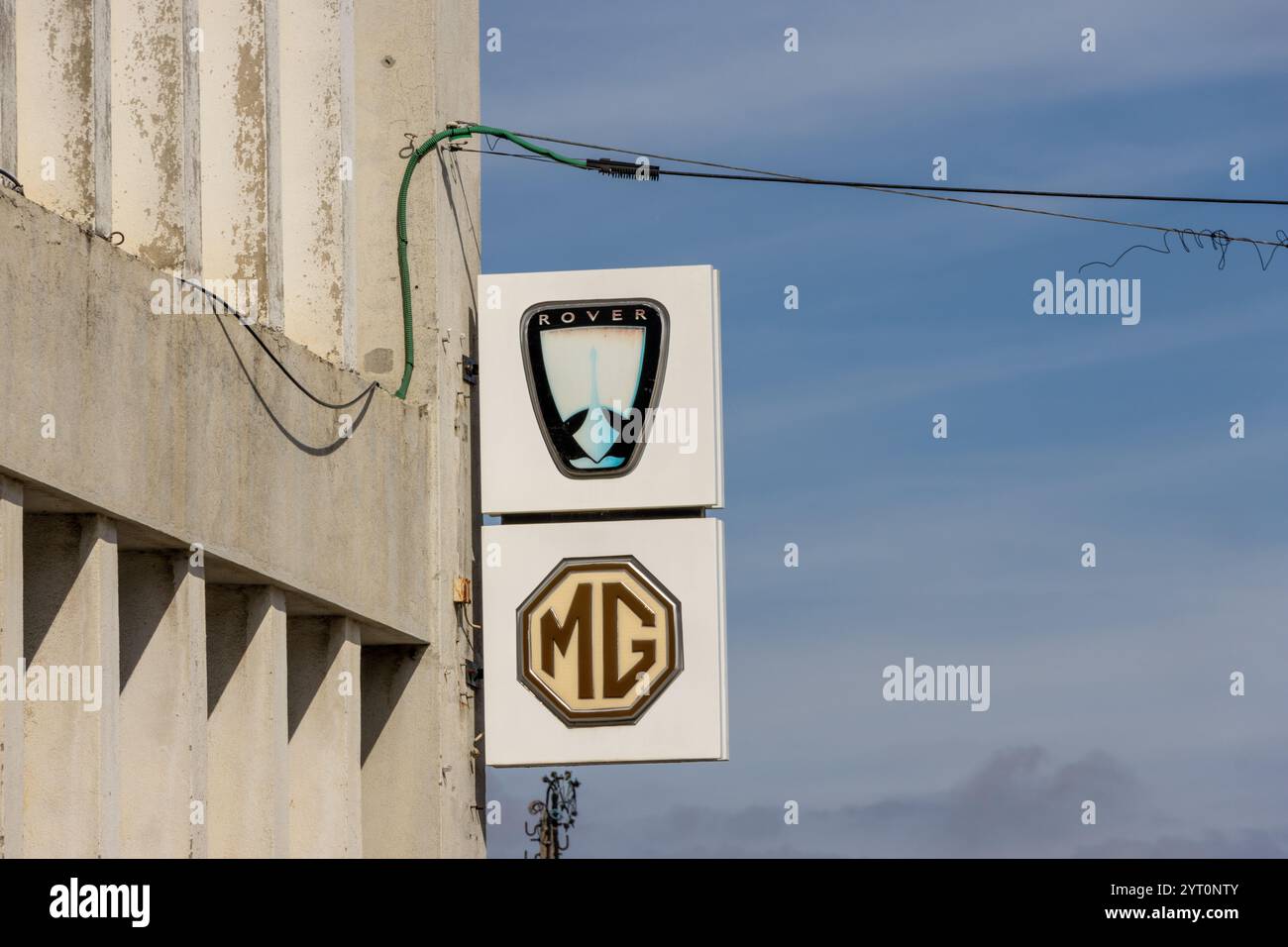 Old signage displaying logos of rover and mg, two iconic british car ...