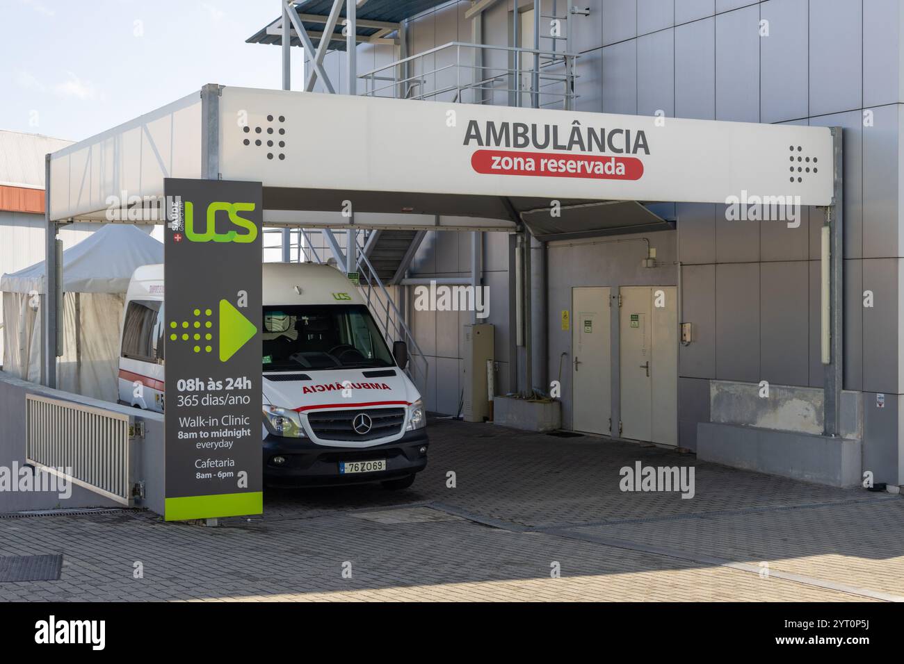 Modern ambulance parked under a sign at the ucs health care unit, ready ...