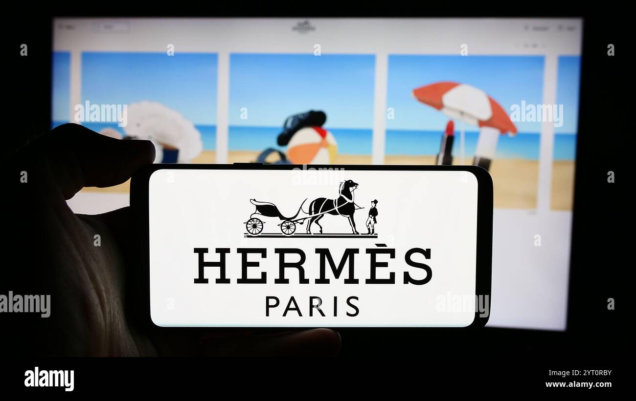 In this photo illustration, a person is holding a smartphone with the ...