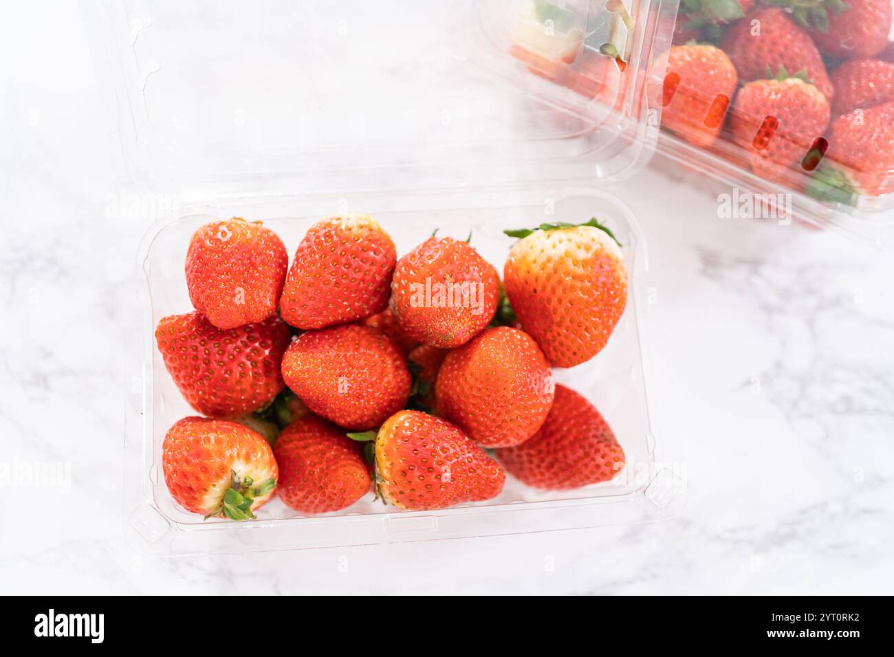 Store-Bought Strawberries in a Plastic Container on the Kitchen Counter ...