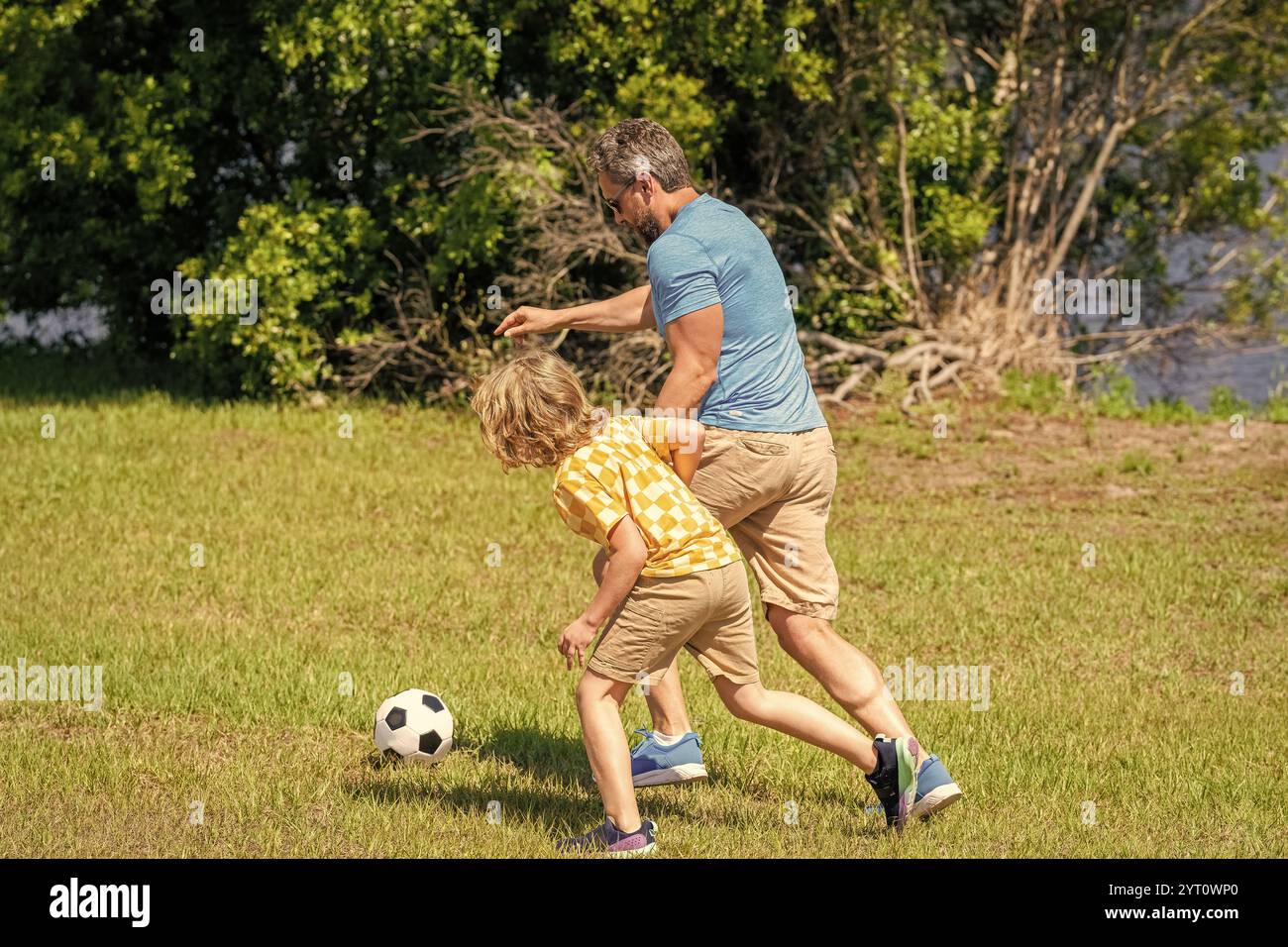 dad and son playing football during their childhood. Childhood memories ...