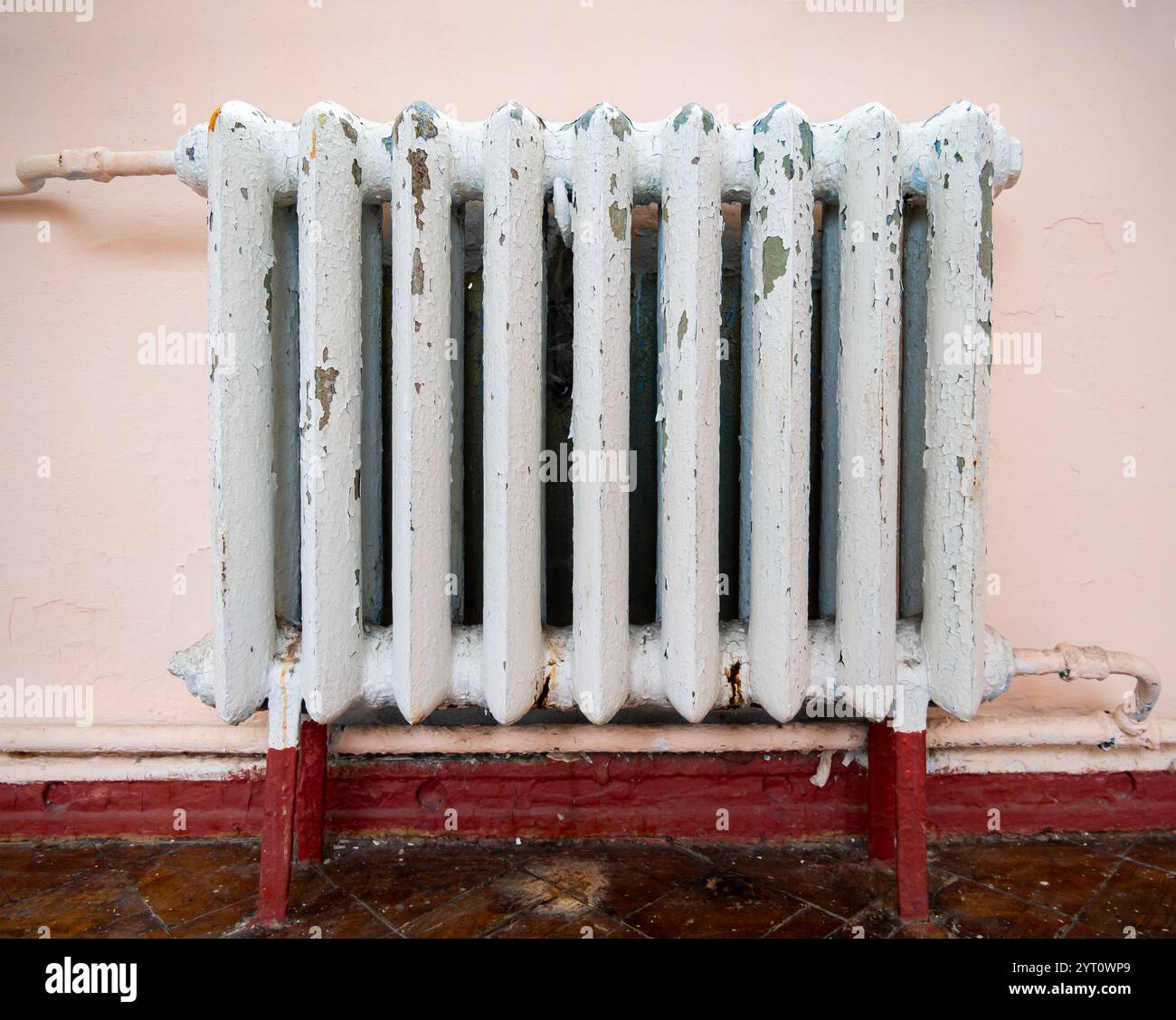 Old cast iron heating radiator with peeling paint Stock Photo - Alamy