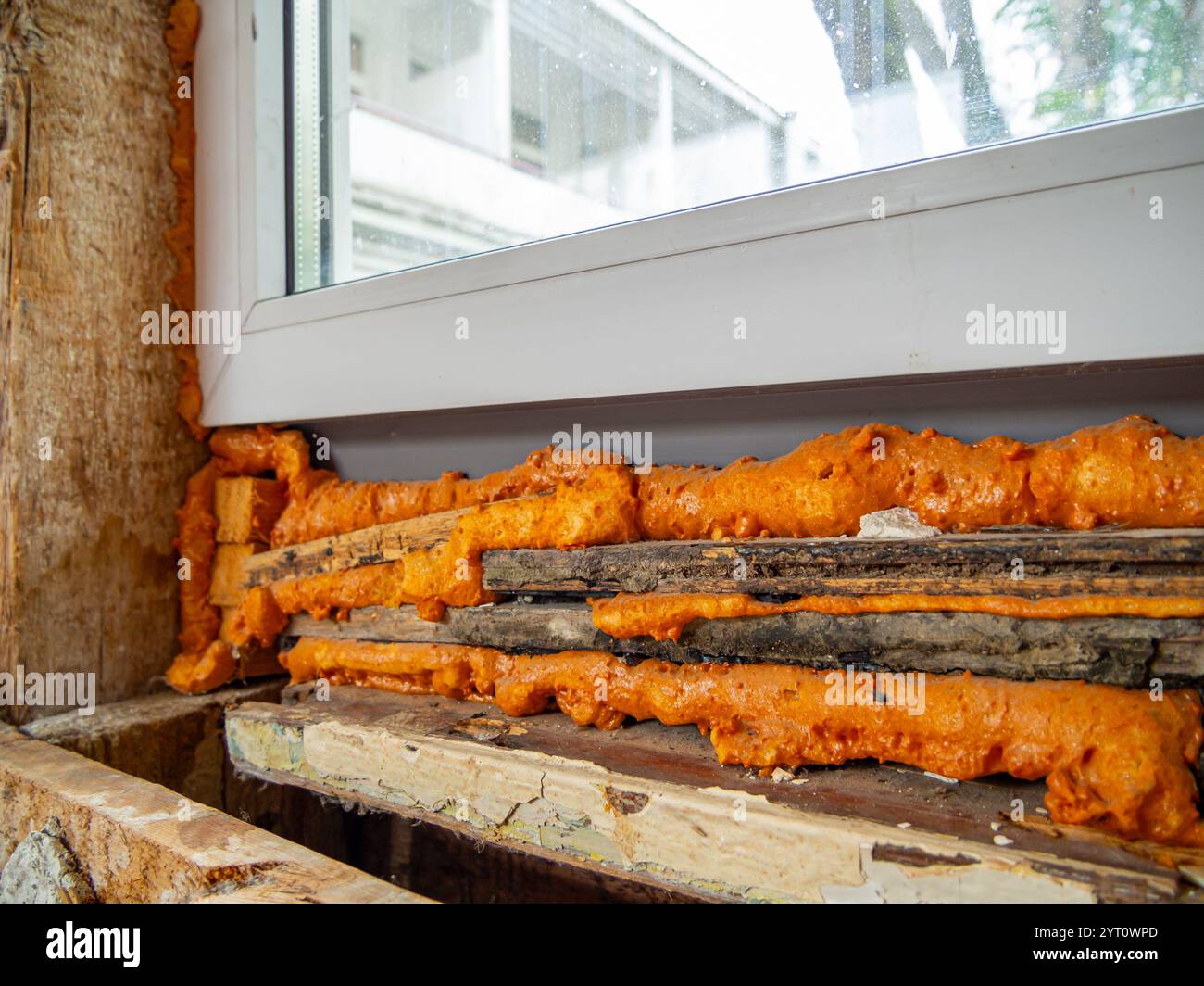 Putting old boards under the window during its installation to reduce ...