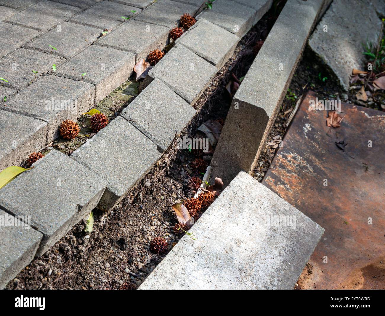 The collapsed edge of a pedestrian cobblestone path Stock Photo - Alamy