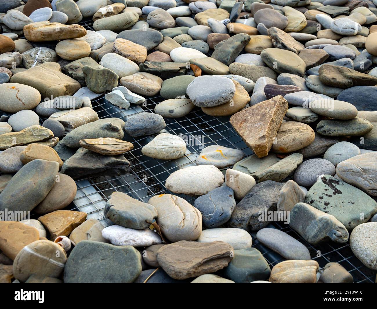 Decorative coating of sea pebbles on top of a corrugated sheet base ...