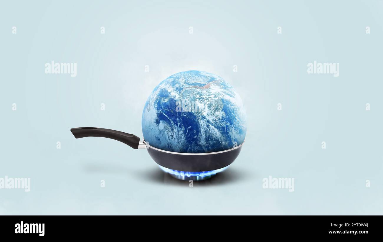 Planet earth burns in a frying pan on a gas burner on a blue background ...