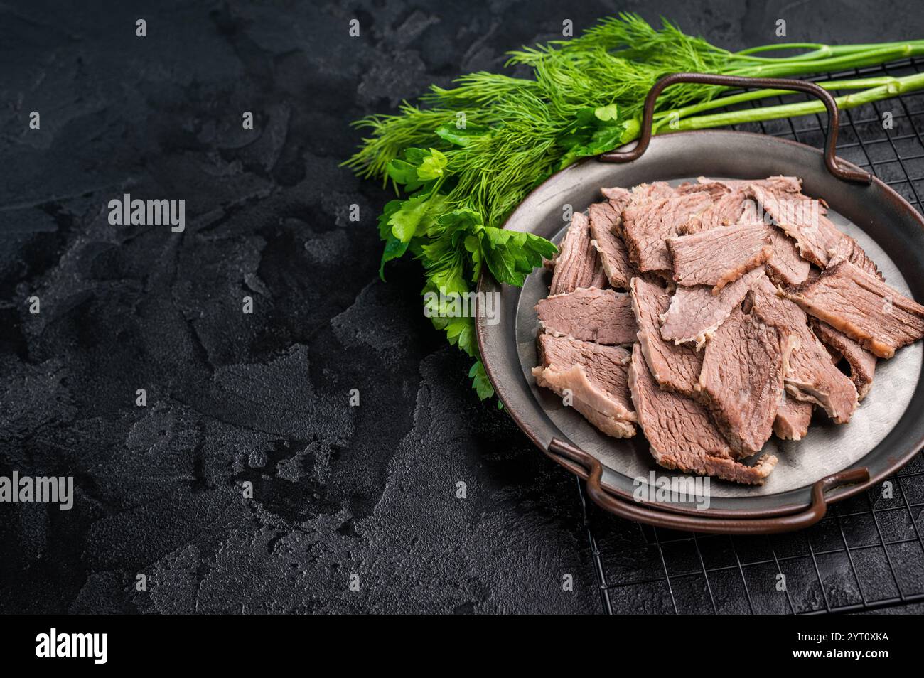 Boiled sliced beef meat in a steel tray. black background. top view ...