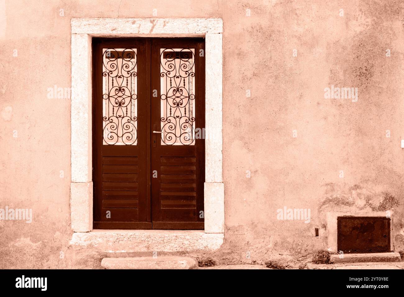 Old brown wooden door with ornament on the wall. Demonstrating color of ...