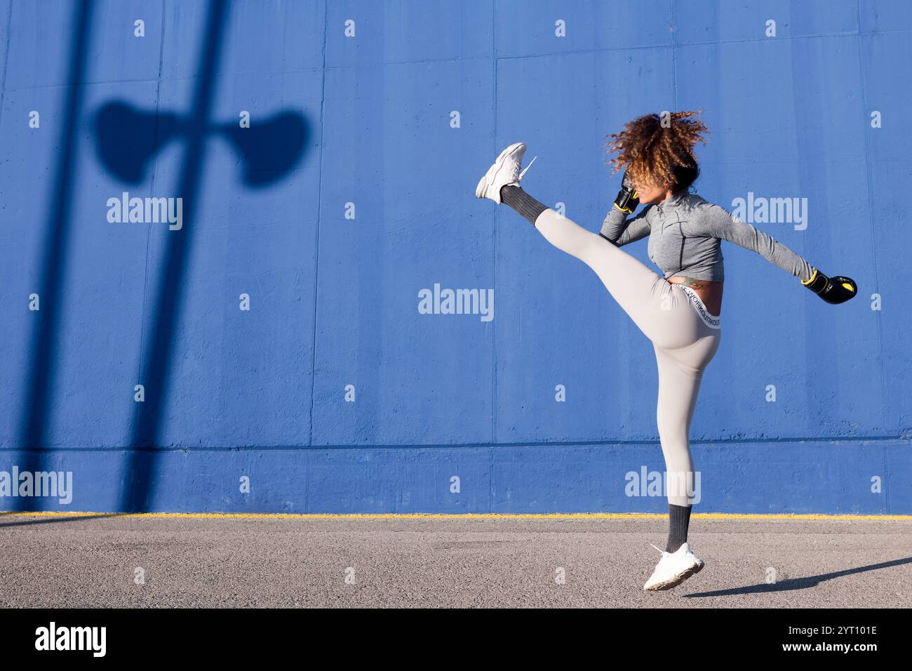 latin female fighter kicking with raised leg Stock Photo - Alamy