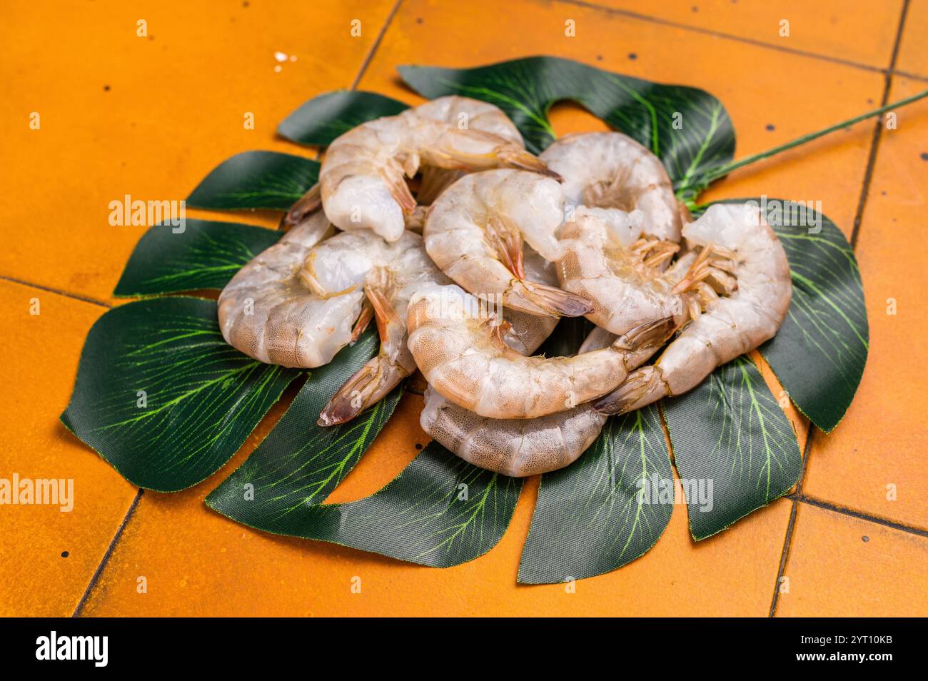 Uncooked Raw white shrimps prawns. Top view. Orange background Stock ...