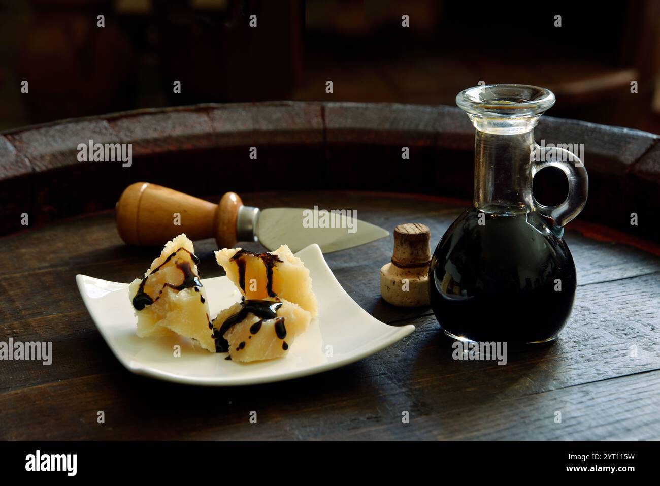 Balsamic Vinegar of Modena with Parmesan flakes set on plates and a ...