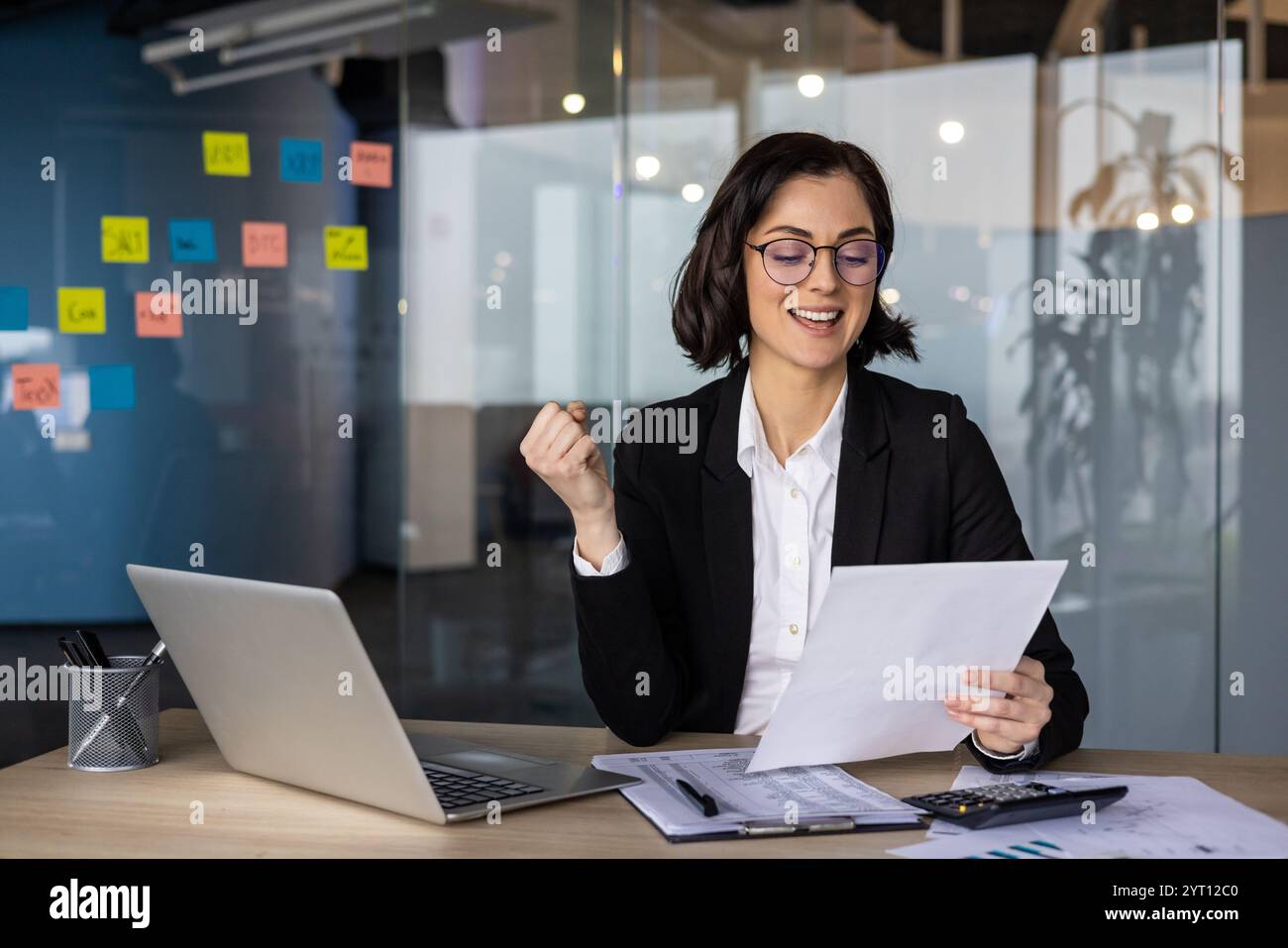 Motivated female professional reviews business hi-res stock photography ...