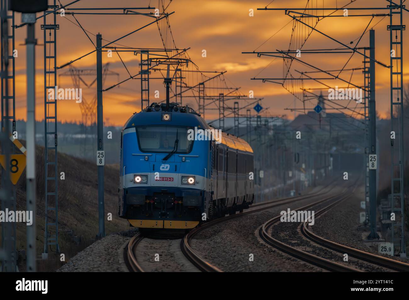 Fast passenger electric trains with sunset cloudy color near Neplachov ...