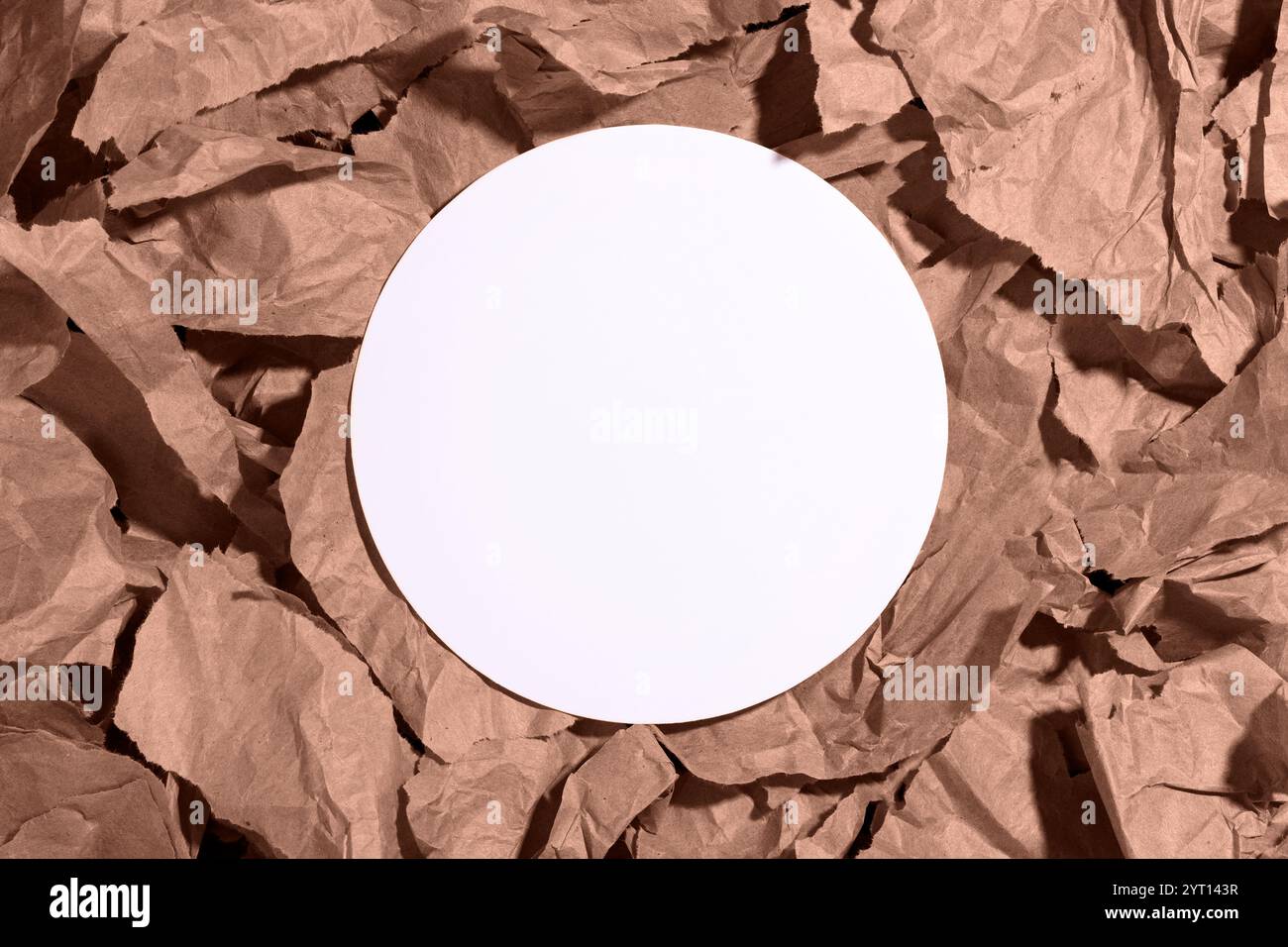 White empty blank circle mockup on multiple pieces of torn brown, mocha ...