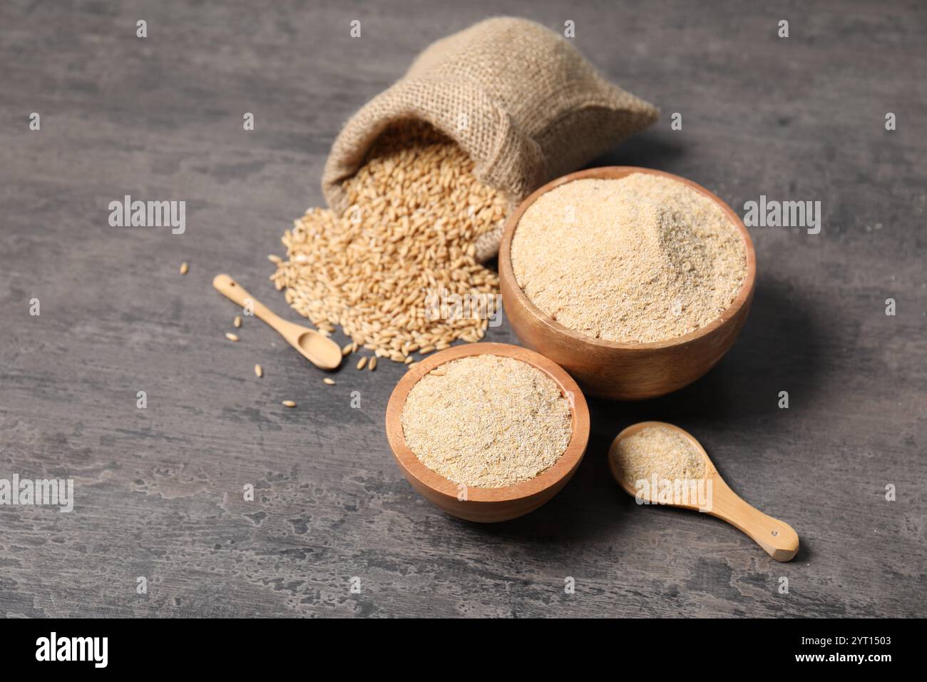 Oat bran and grains on grey table Stock Photo - Alamy