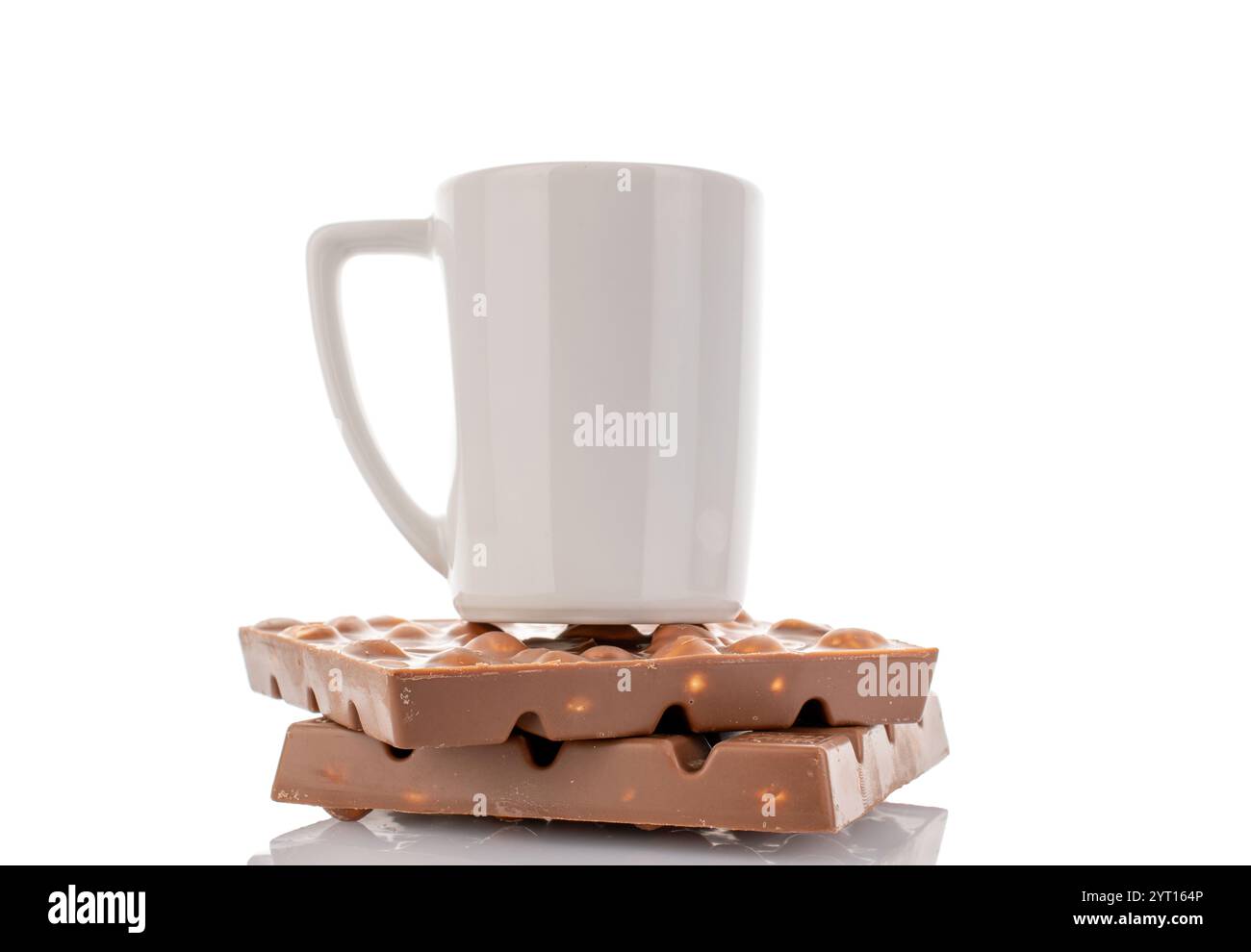 Two bars of dark chocolate with hazelnuts in a ceramic dish, close-up ...