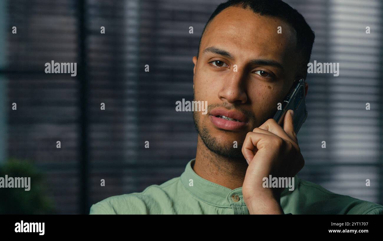 Serious worried excited latin american man talking mobile phone sad ...