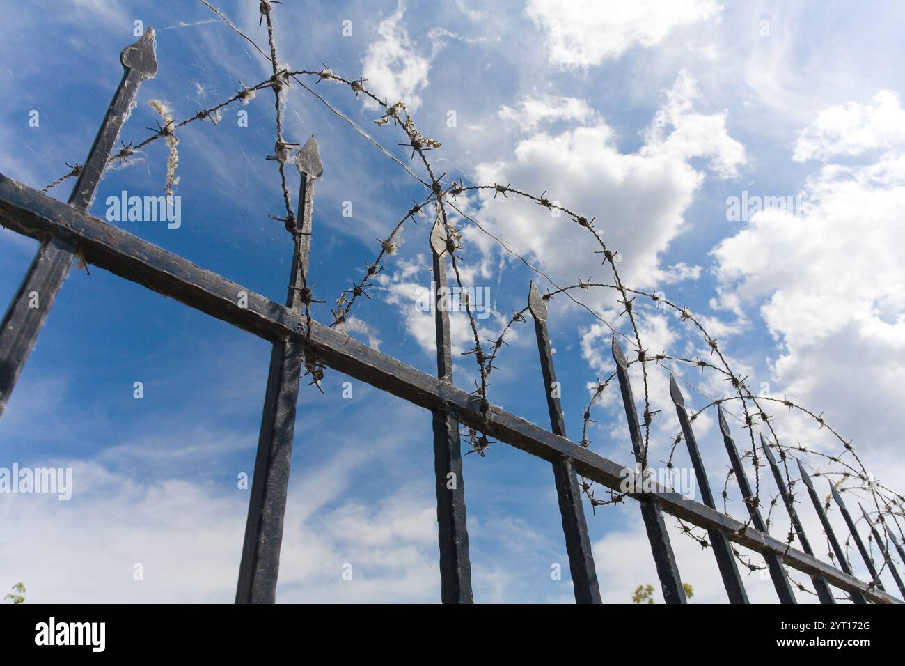 the barbed wire fence of protected prison territory. High quality photo ...