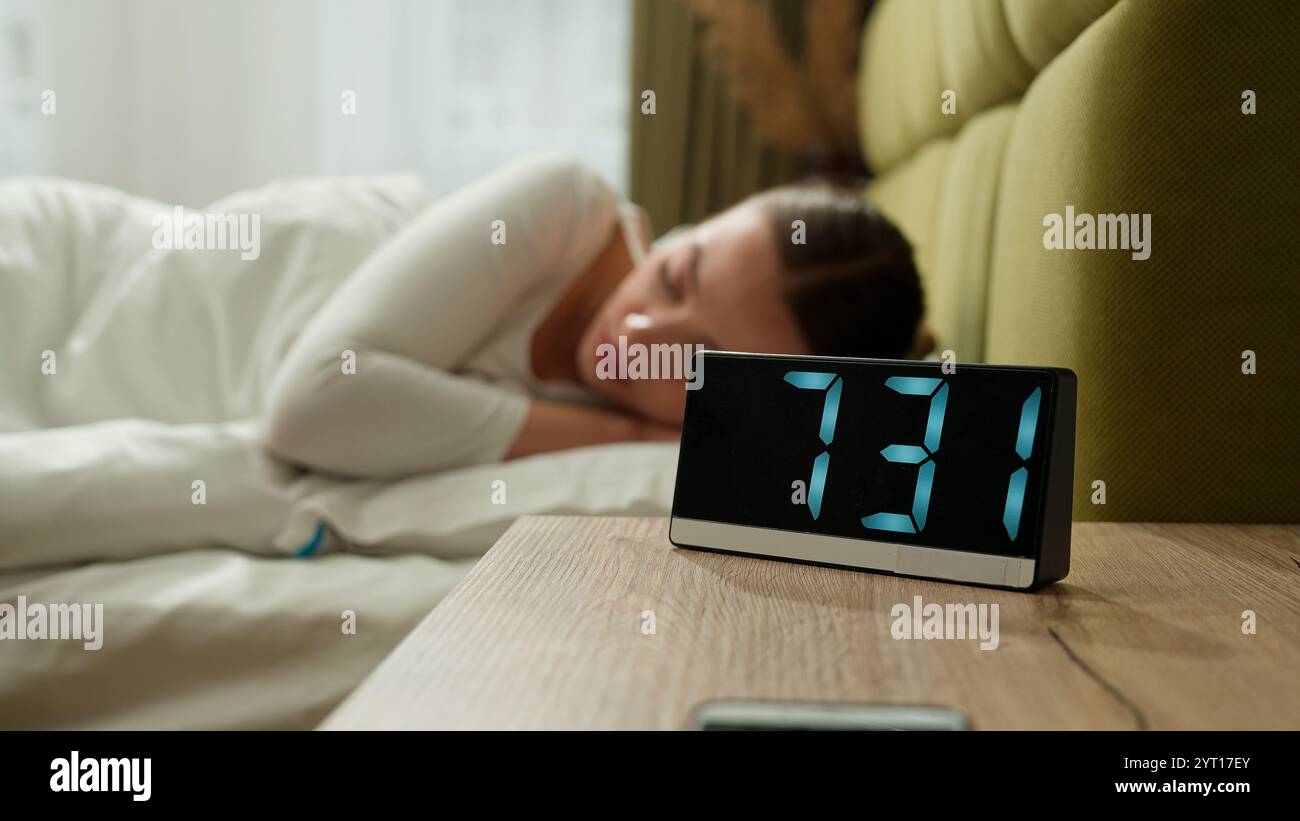 Angry annoyed tired exhausted girl wake up in morning bed home bedroom ...