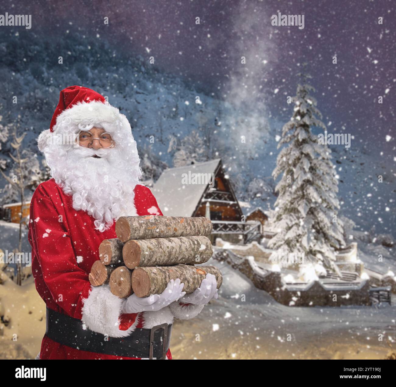 Santa claus holding firewood for heating in front of a mountain house ...
