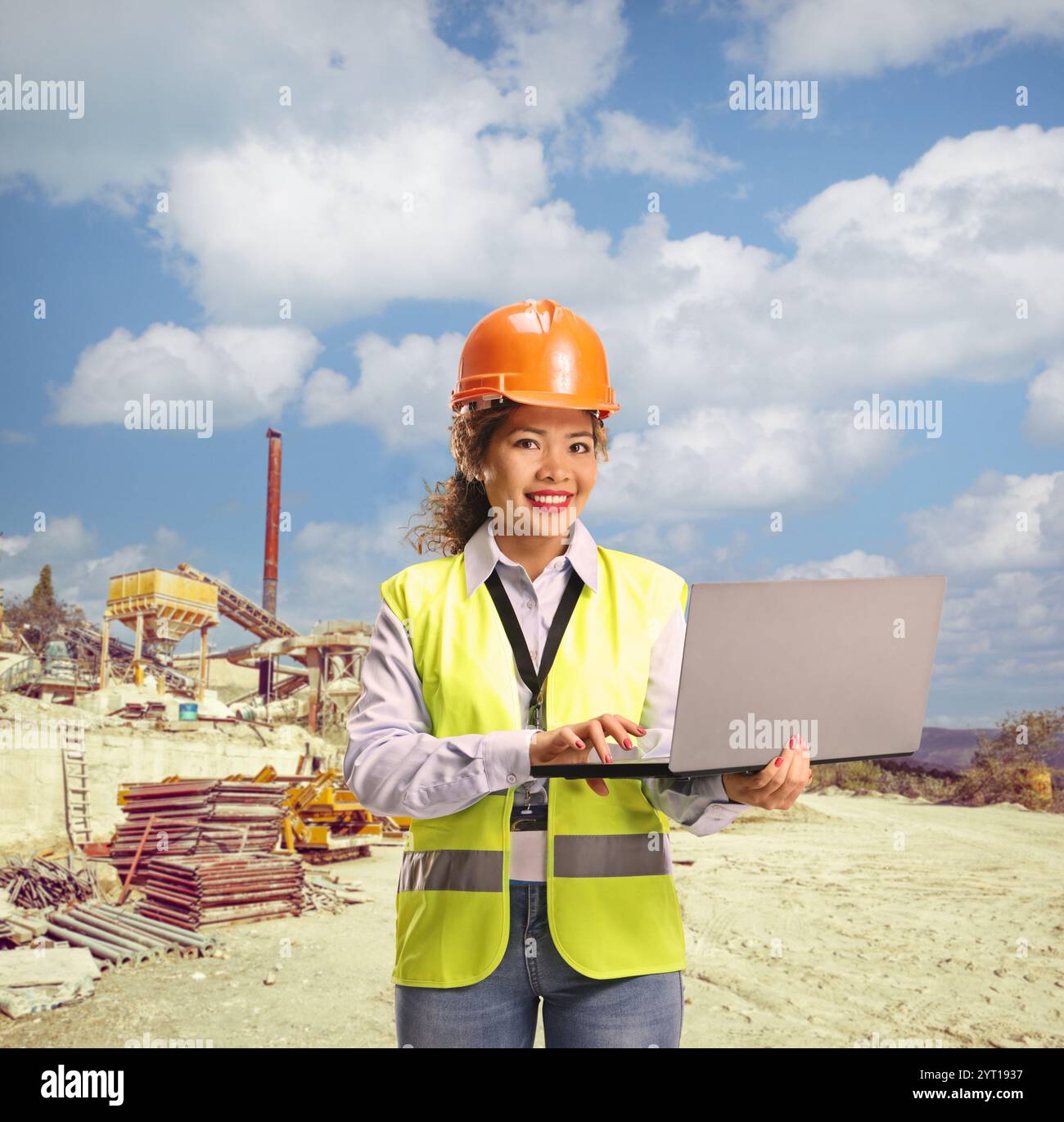 Female asian engineer working on a laptop computer at a construction ...