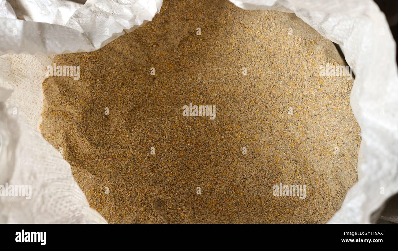 white open top bag with dry mixed feed for farm poultry, combined ...