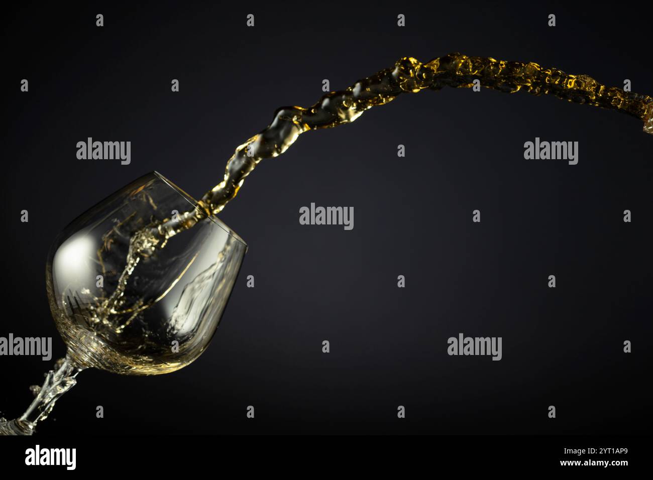 Snifter and brandy splash on a black background. Copy space Stock Photo ...
