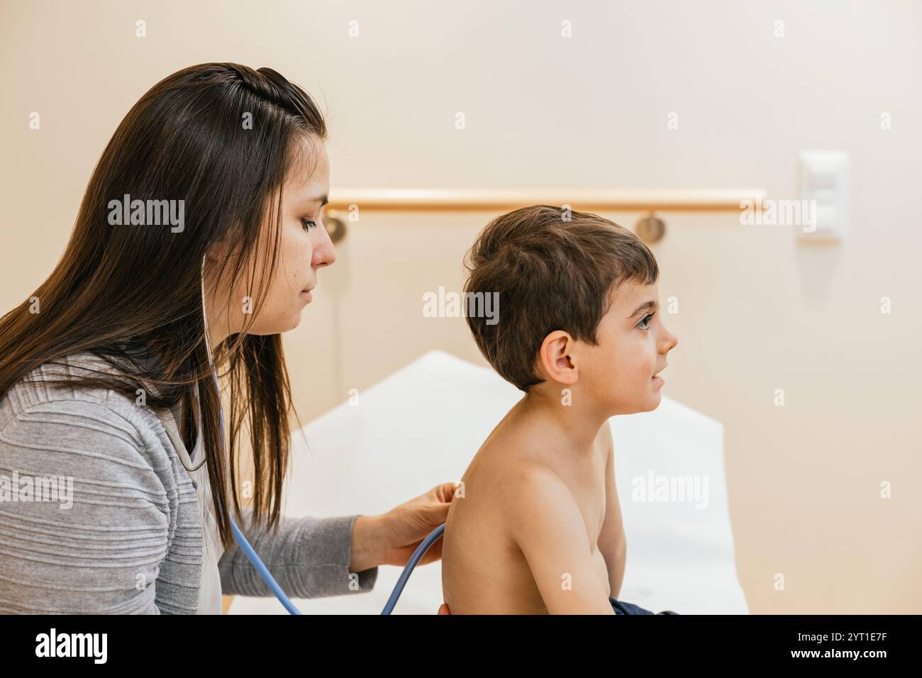 Doctor examining child's lungs with stethoscope during respiratory ...