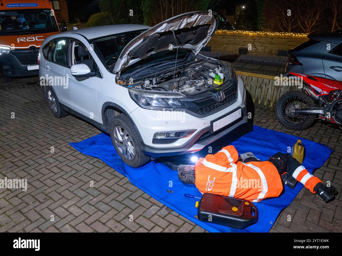 RAC mechanic servicing a car on customers driveway, UK Stock Photo - Alamy