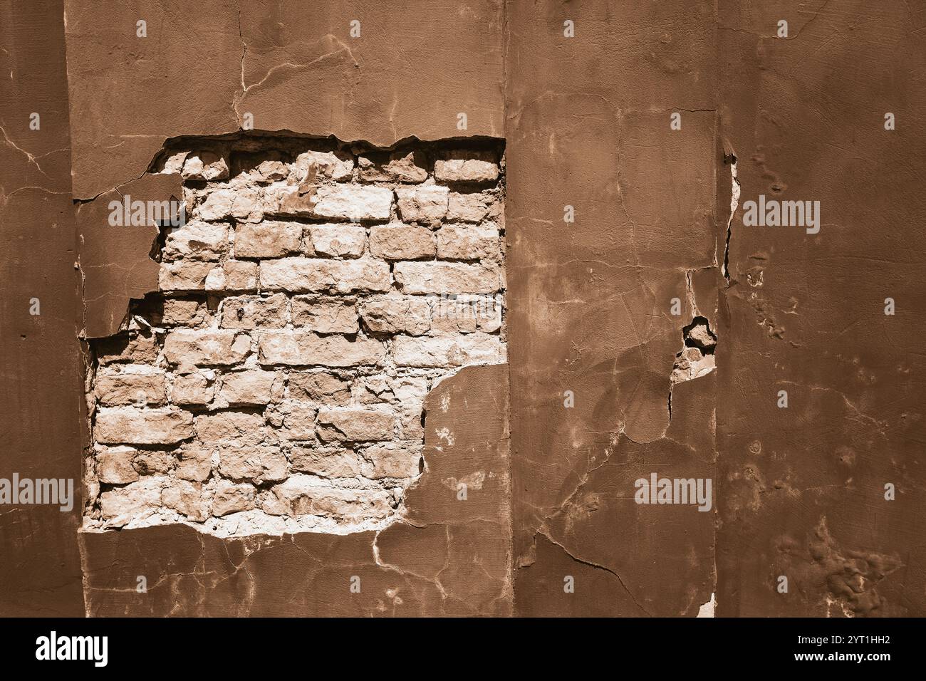 Exposed brick wall with peeling plaster in Mocha and Mousse tones Stock ...