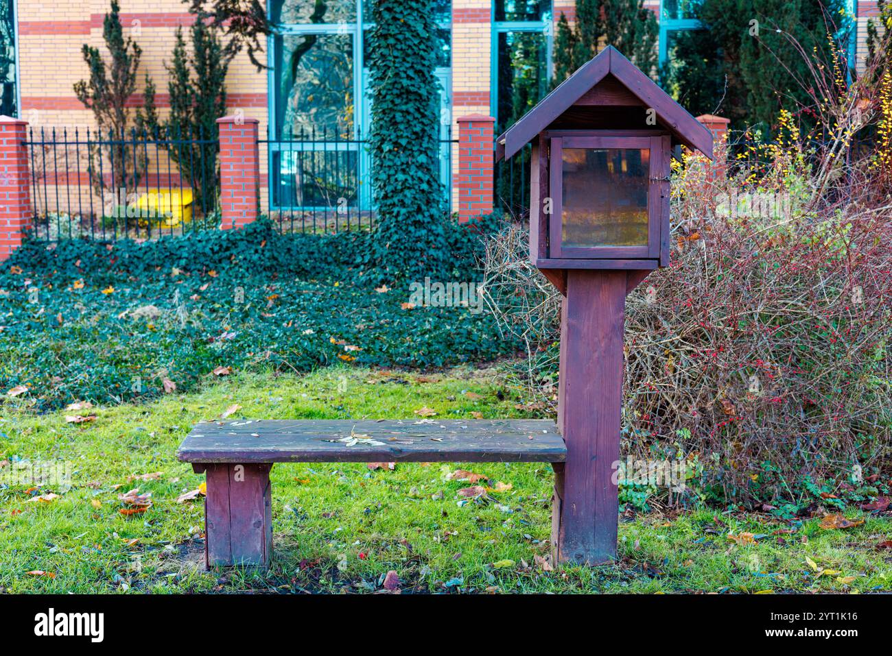 A wooden bench in the park with a box for exchanging and reading books ...