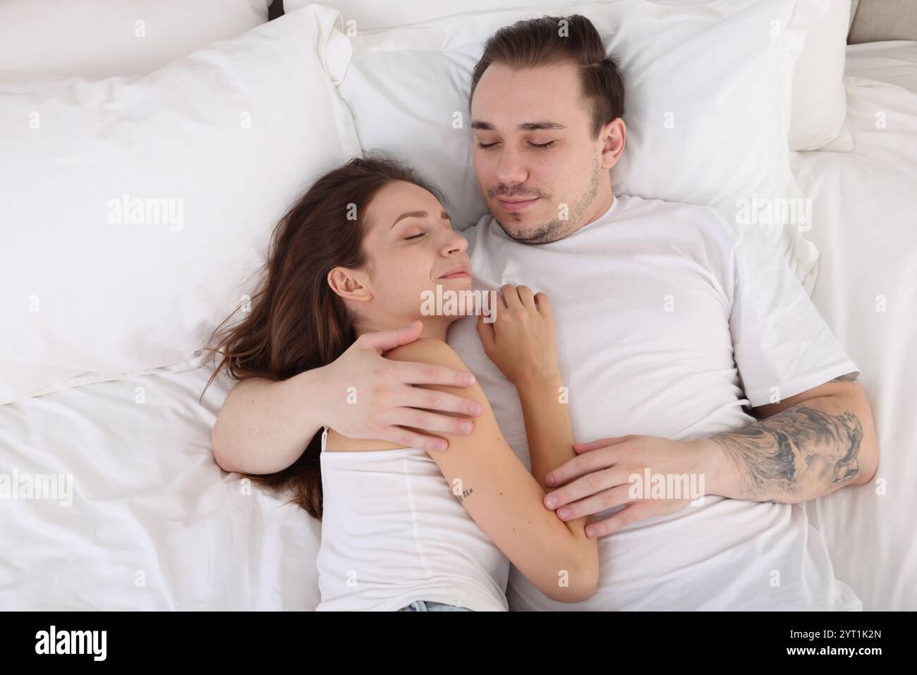 Cute couple napping on bed at home, top view Stock Photo - Alamy