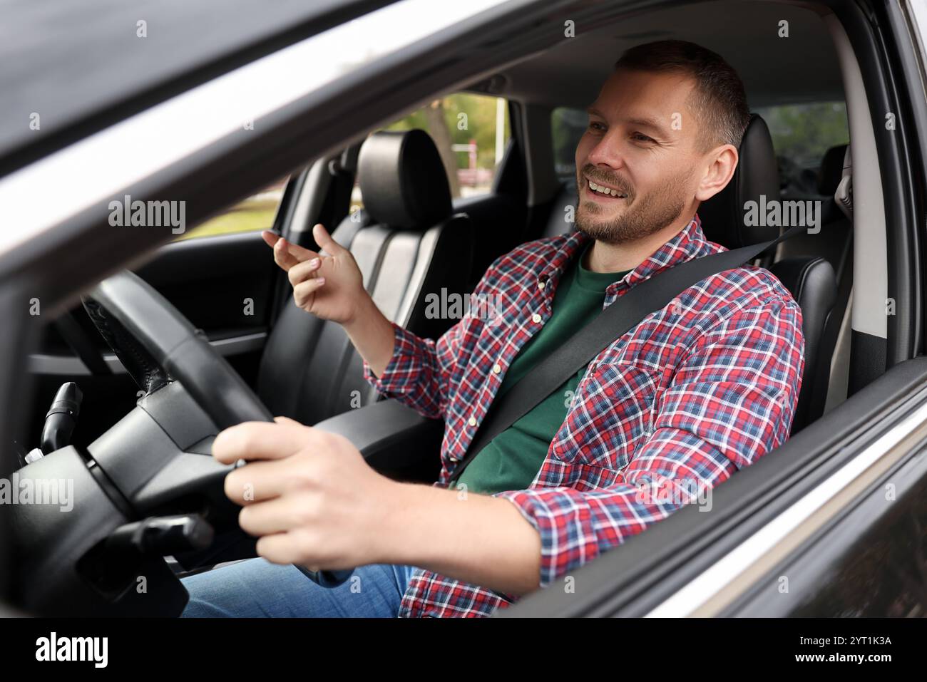 Man driving modern car, view through window Stock Photo - Alamy