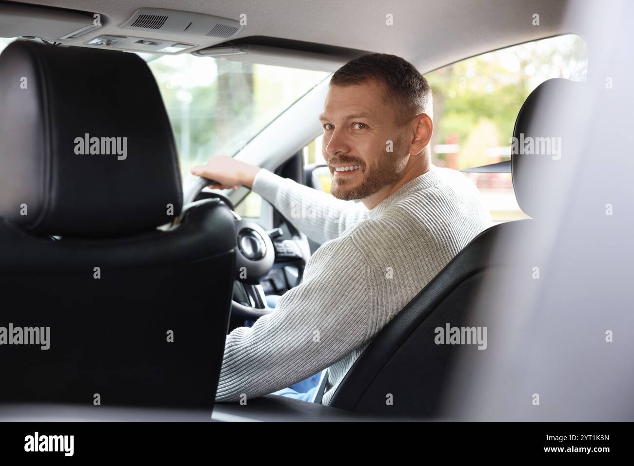 Happy man behind steering wheel of modern car Stock Photo - Alamy