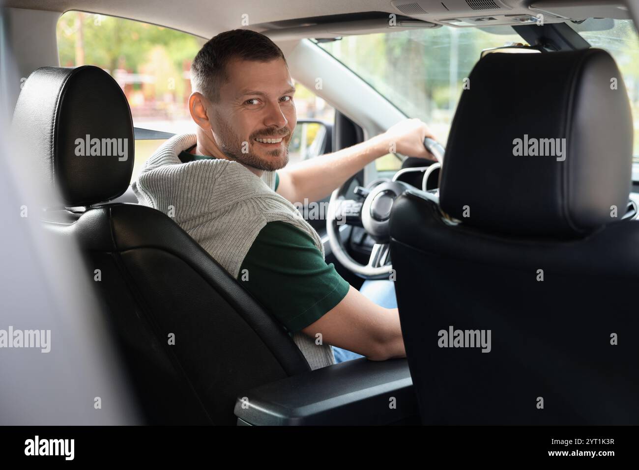 Happy man behind steering wheel of modern car Stock Photo - Alamy