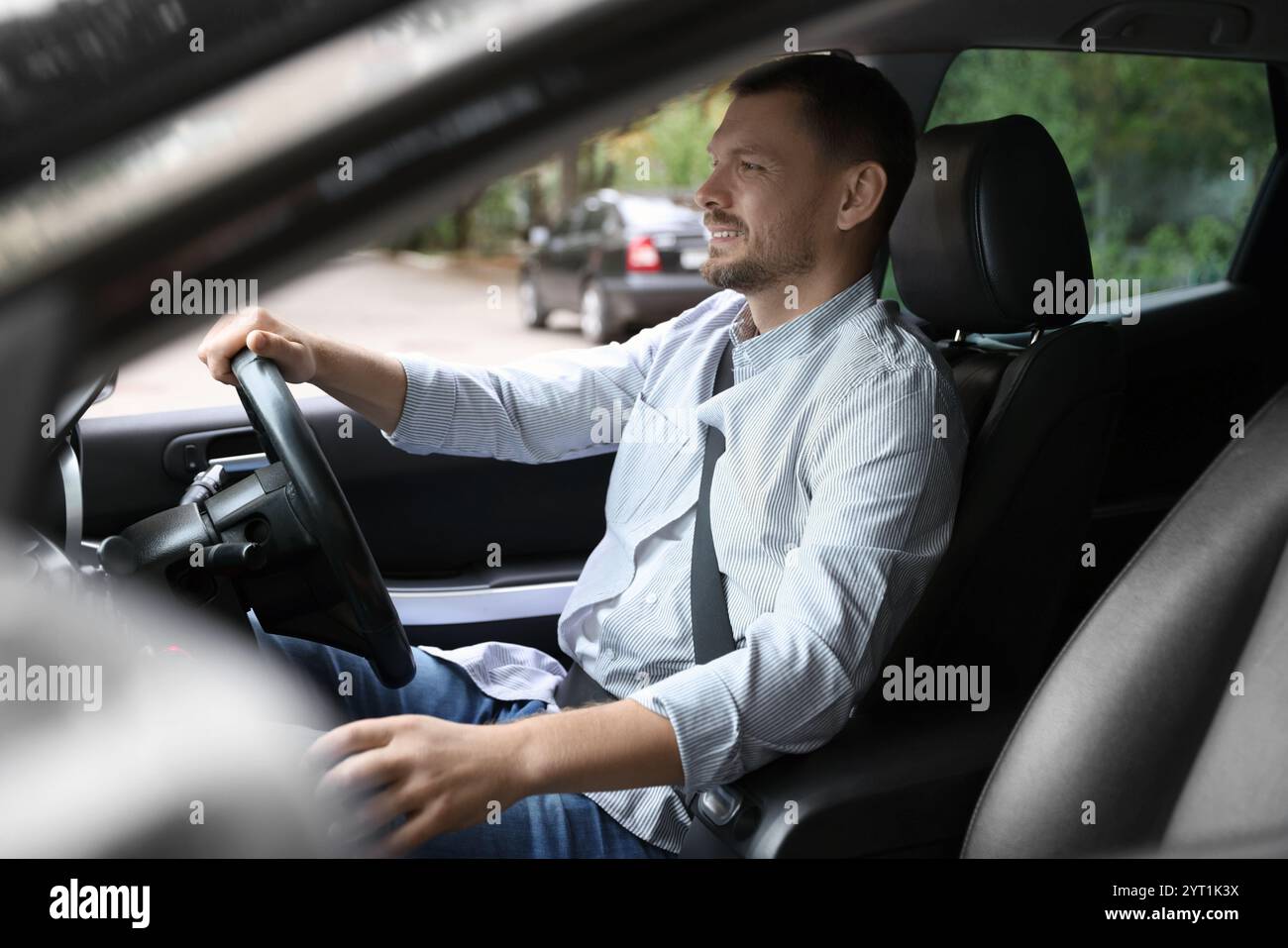 Man driving modern car, view through window Stock Photo - Alamy
