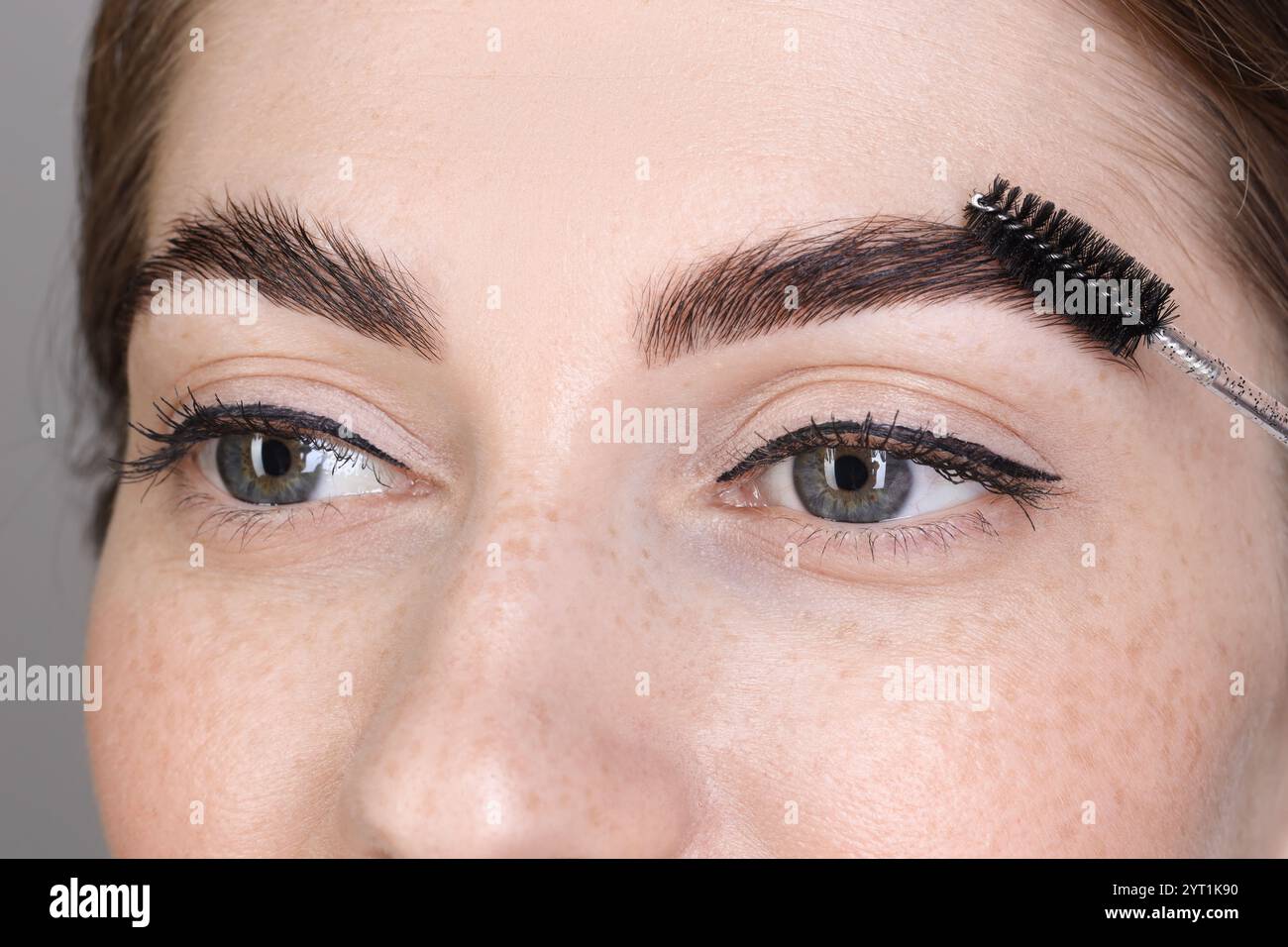 Brow lamination. Woman combing eyebrows with brush, closeup Stock Photo ...