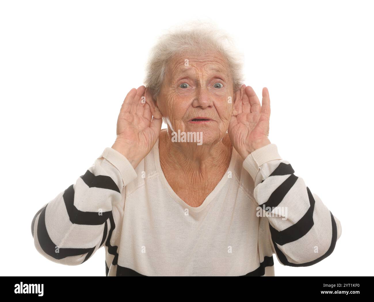 Senior woman showing hand to ear gesture on white background Stock ...