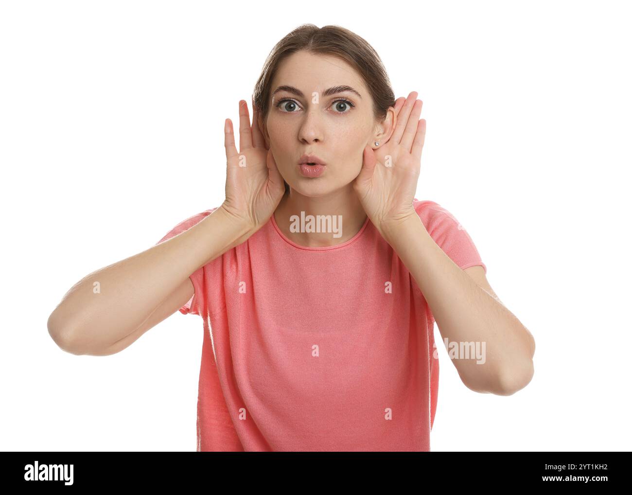Woman showing hand to ear gesture on white background Stock Photo - Alamy