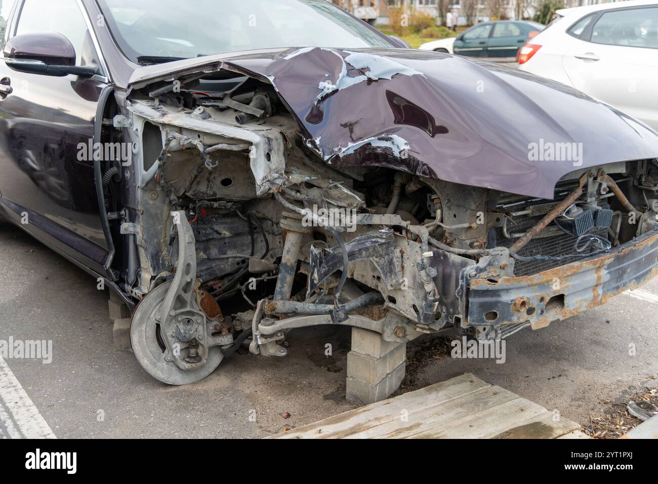 A passenger car is parked in the parking lot with damage to the right ...