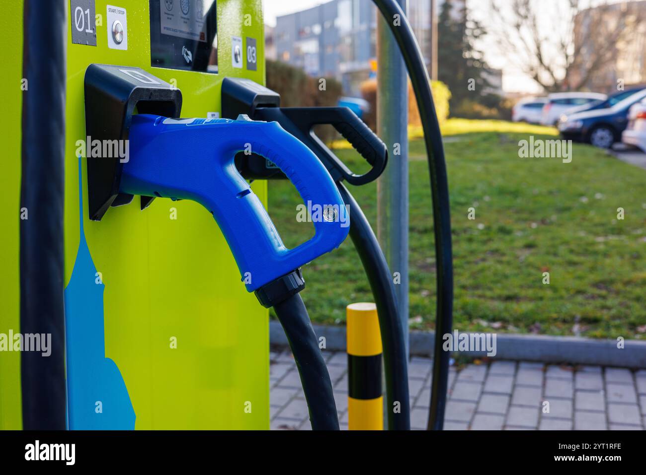 Two charging station gas guns for electric vehicles Stock Photo - Alamy