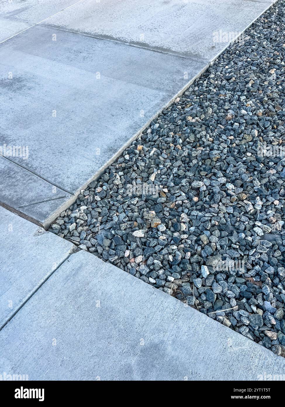 Concrete Sidewalk and Decorative Rock Border Stock Photo - Alamy