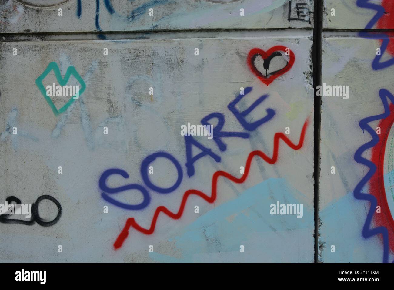 The SOARE inscription is made with wavy red and blue lines from spray ...