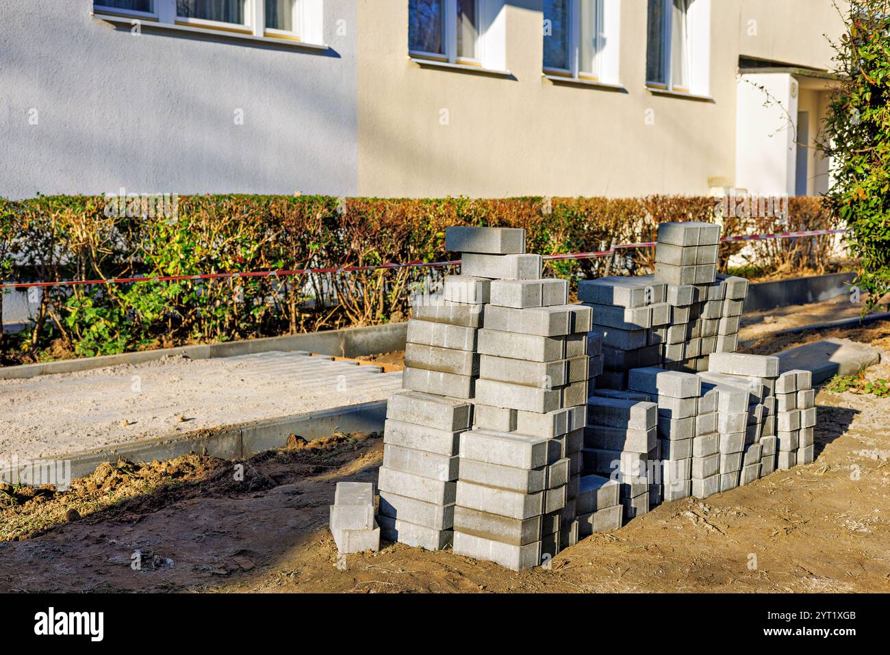 Stacks of paving slabs in front of the pedestrian path of the house ...