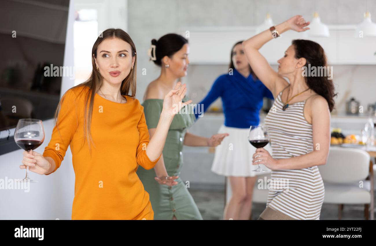 Smiling women dancing at a bachelorette party - girlfriends home party ...