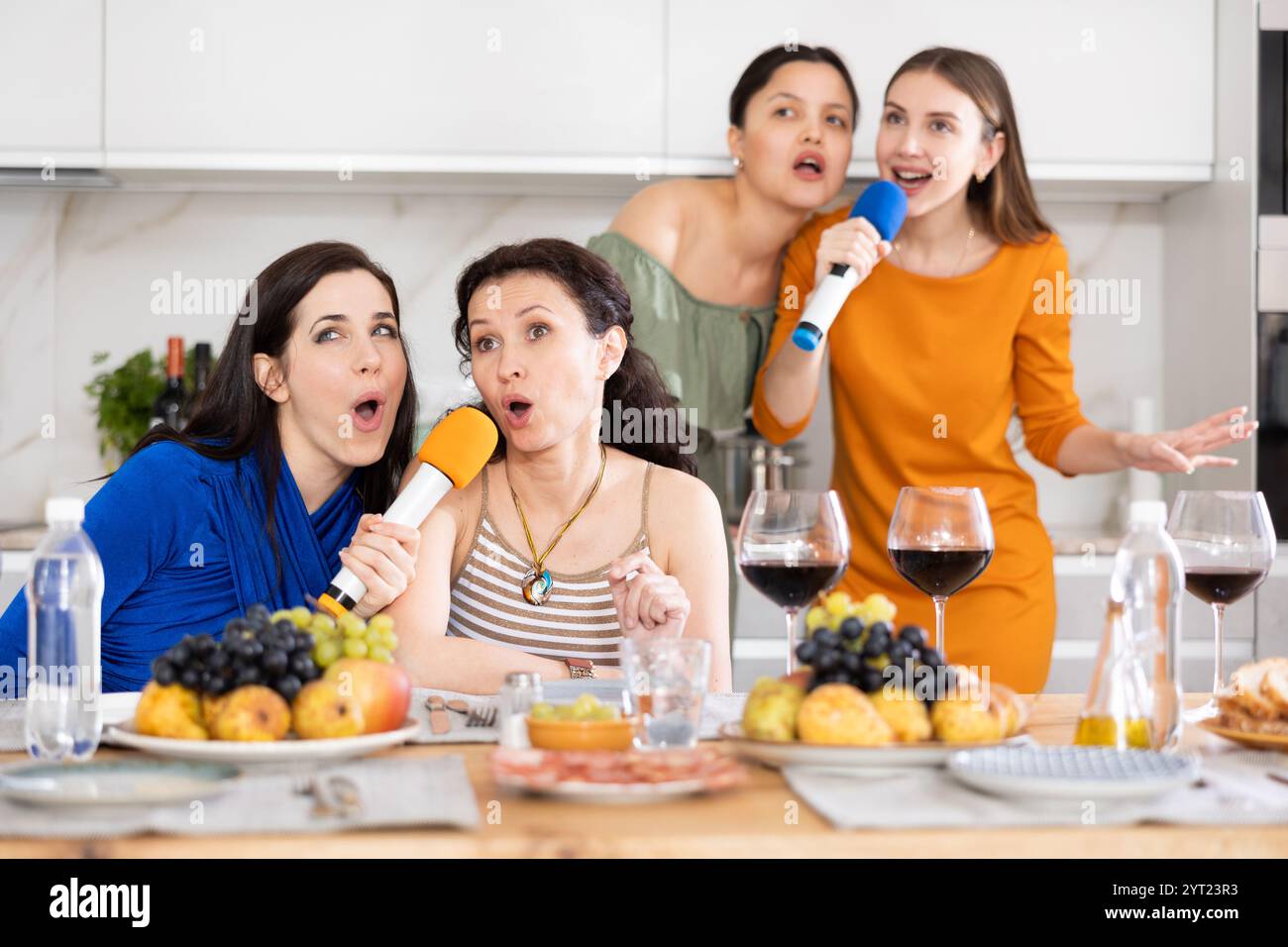 Group of women friends singing karaoke Stock Photo - Alamy