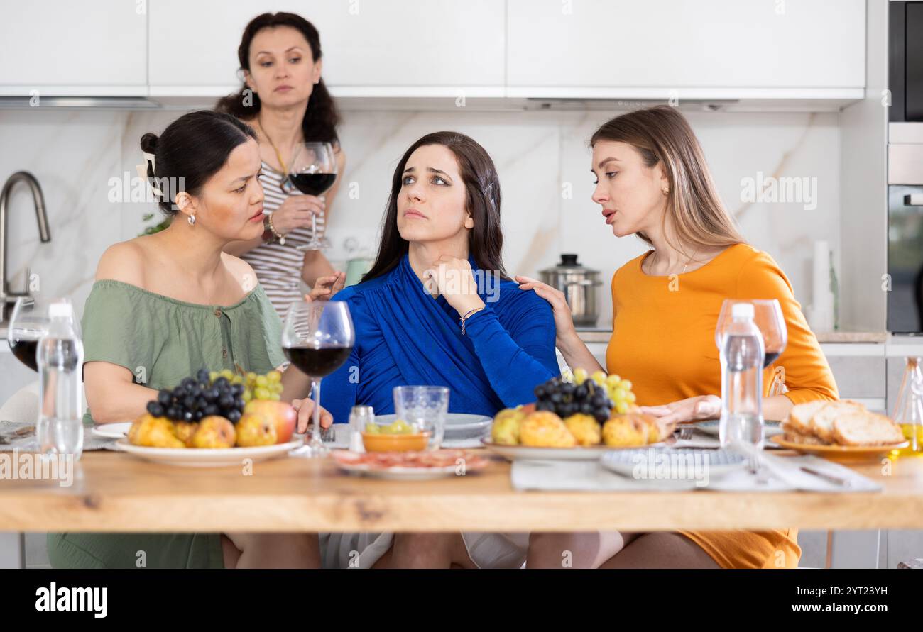 Group of female friends calming woman Stock Photo - Alamy