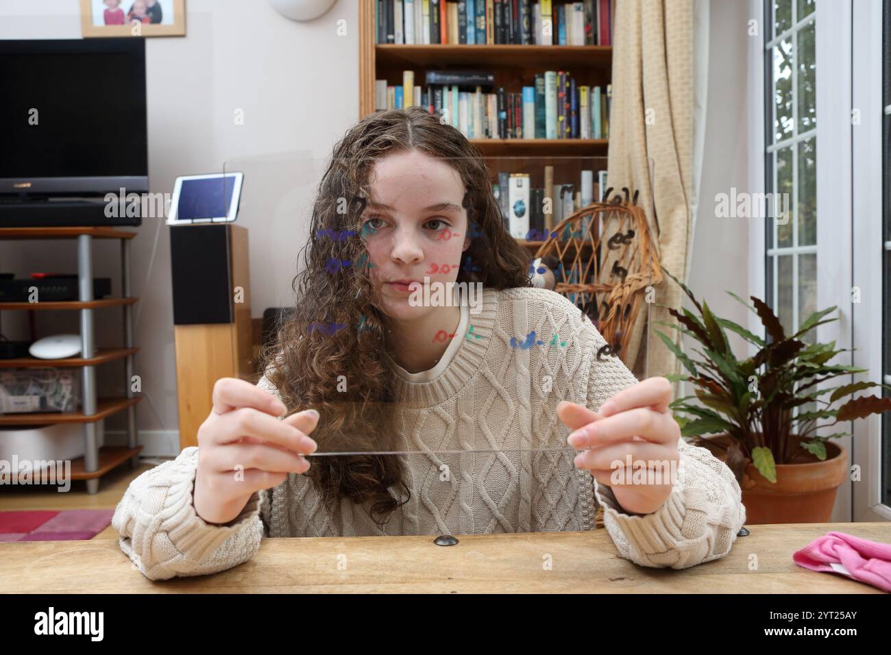 Teenage girl revising Latin on a whiteboard revision learning student ...